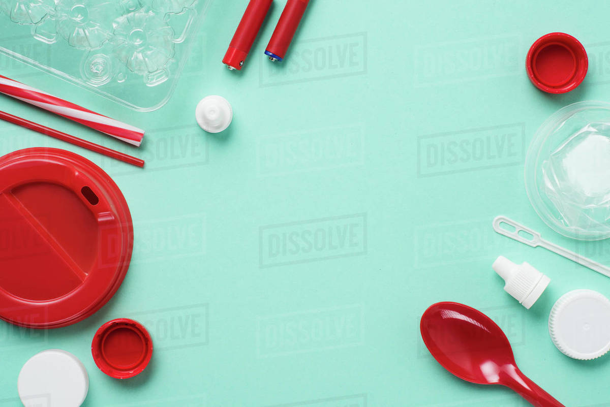 Top view of various kinds of disposable plastic waste on blue ...