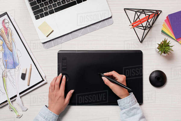 office desk with cropped peson using graphics tablet and pen, flat lay ...