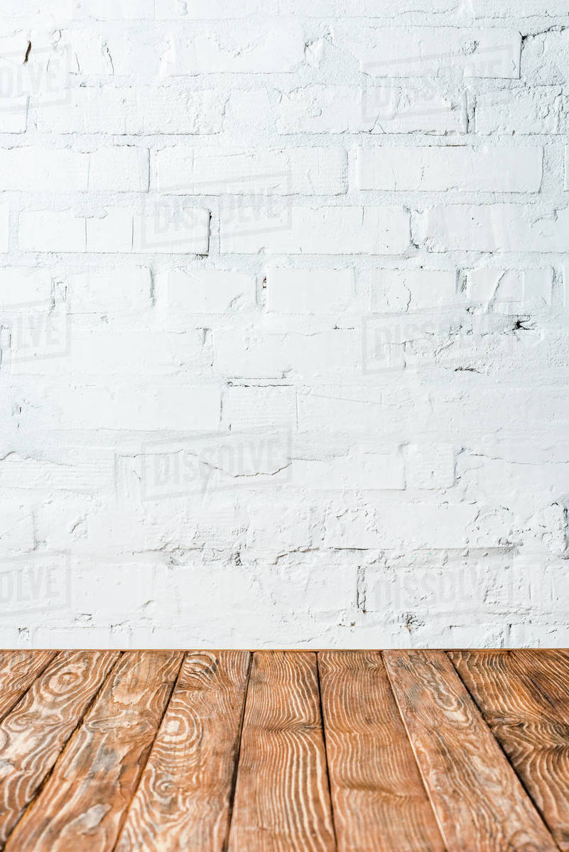 white brick wall and wooden table - Royalty-free Stock Photo | Dissolve