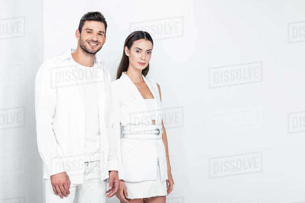 adult stylish smiling couple in total white - Stock Photo - Dissolve