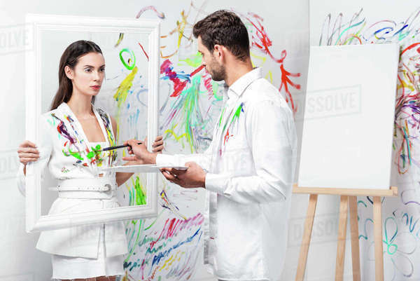 adult man drawing on woman white clothes with paintbrush - Royalty-free ...