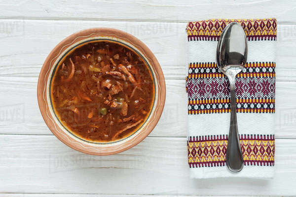 Top view of delicious traditional mixed meat soup with spoon and ...