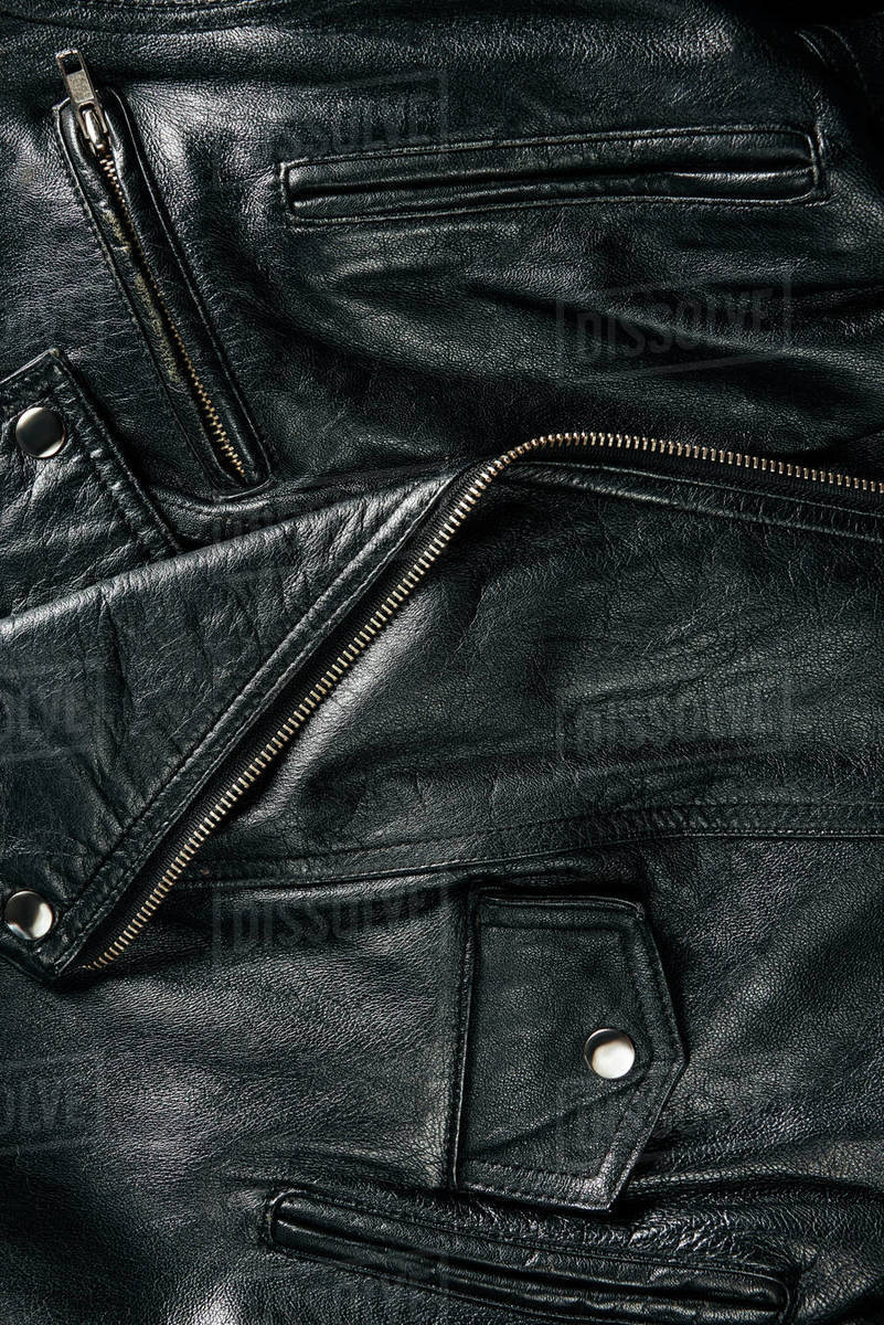 Full frame of black leather jacket as background - Stock Photo - Dissolve