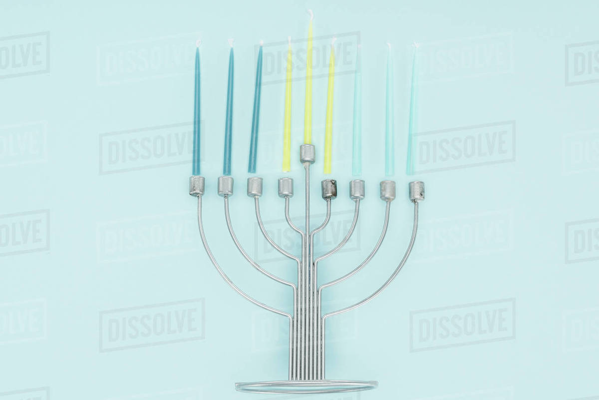 Top view of menorah and candles on blue background, Hanukah celebration ...