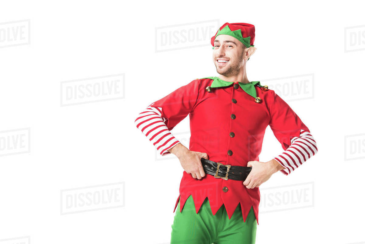 cheerful man in christmas elf costume looking at camera with hands on ...