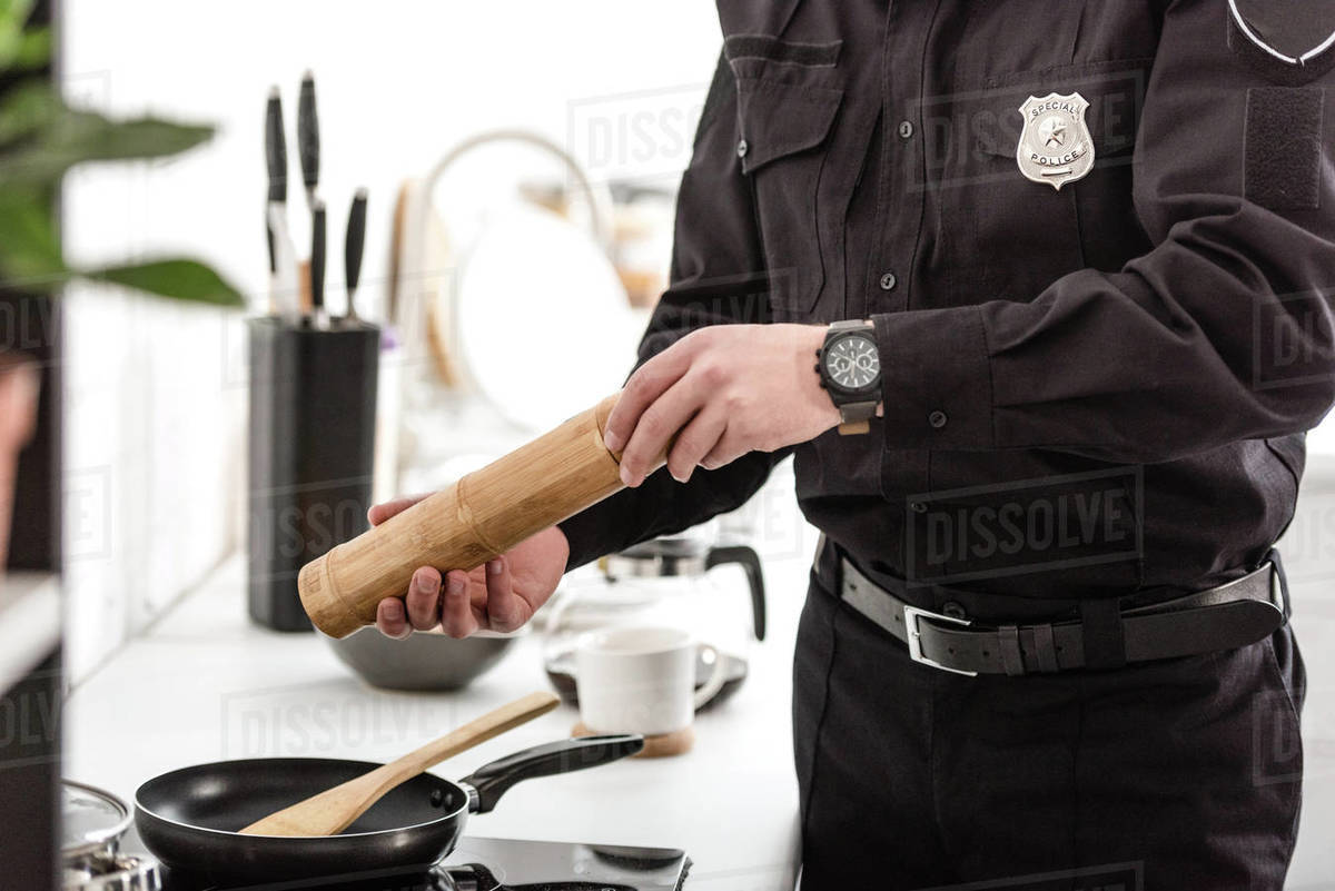 cropped view of police officer cooking breakfast at kitchen - Stock ...