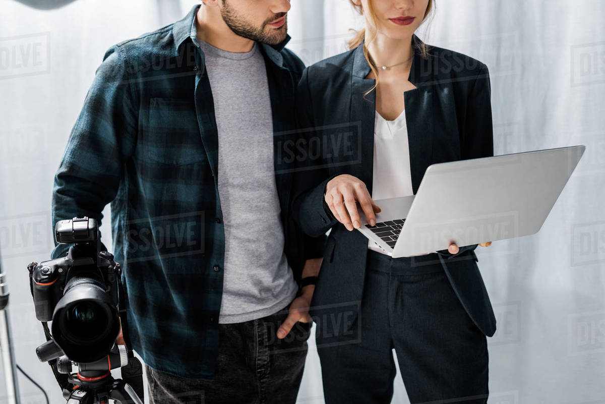 Cropped shot of photographer and model using laptop in studio - Stock ...