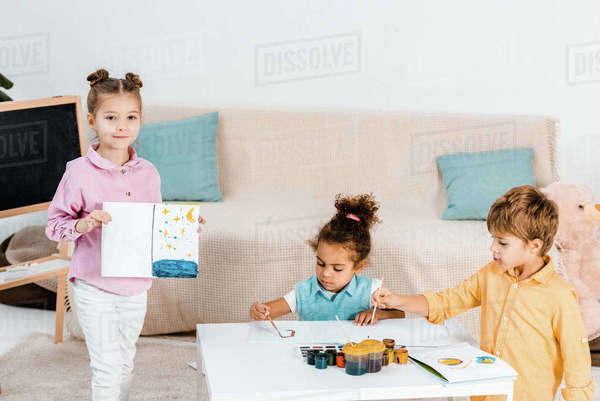 Adorable multiethnic children drawing with paints together - Royalty ...