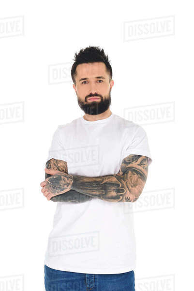 Handsome bearded man with tattoos with crossed arms isolated on white ...