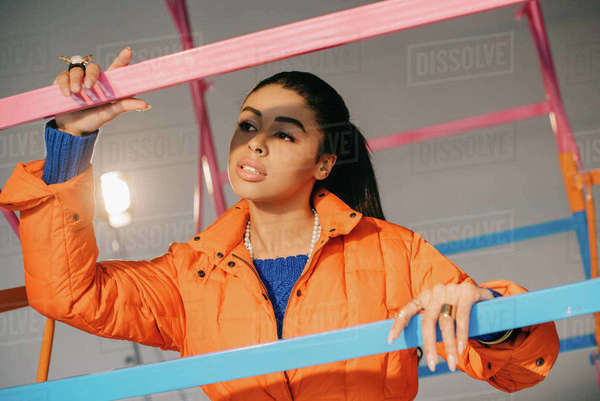 Beautiful African American female model in orange winter jacket posing ...