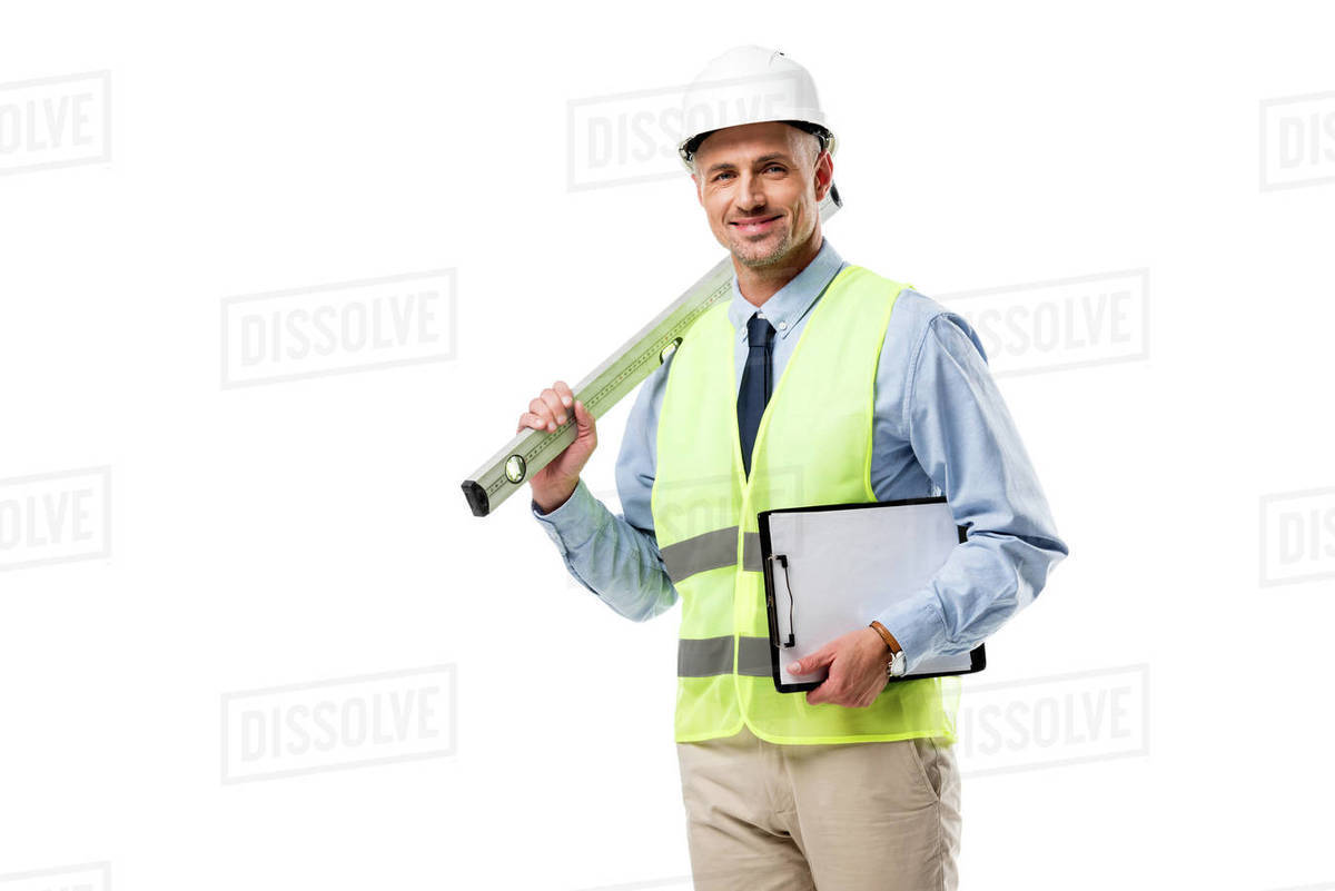 Smiling engineer holding clipboard and spirit level isolated on white ...