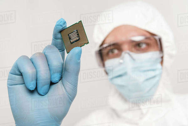 Selective focus of microchip in hand of scientist wearing latex glove ...