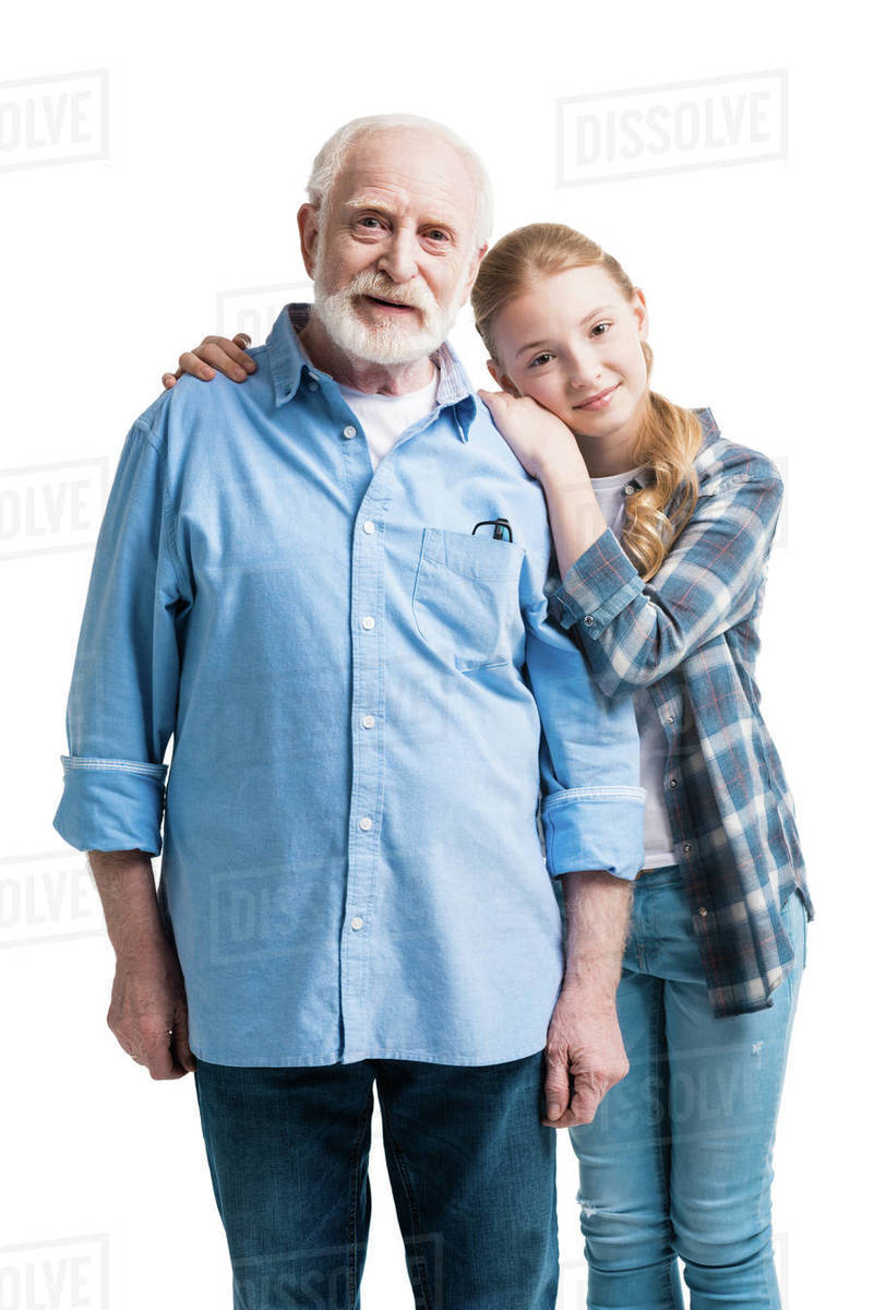 Happy grandfather and granddaughter hugging isolated on white in studio ...