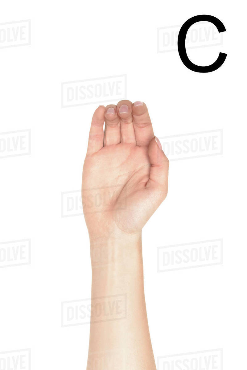 Cropped view of female hand showing latin letter - C, sign language ...