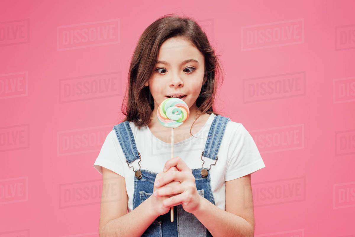 Funny child holding lollipop - Stock Photo - Dissolve
