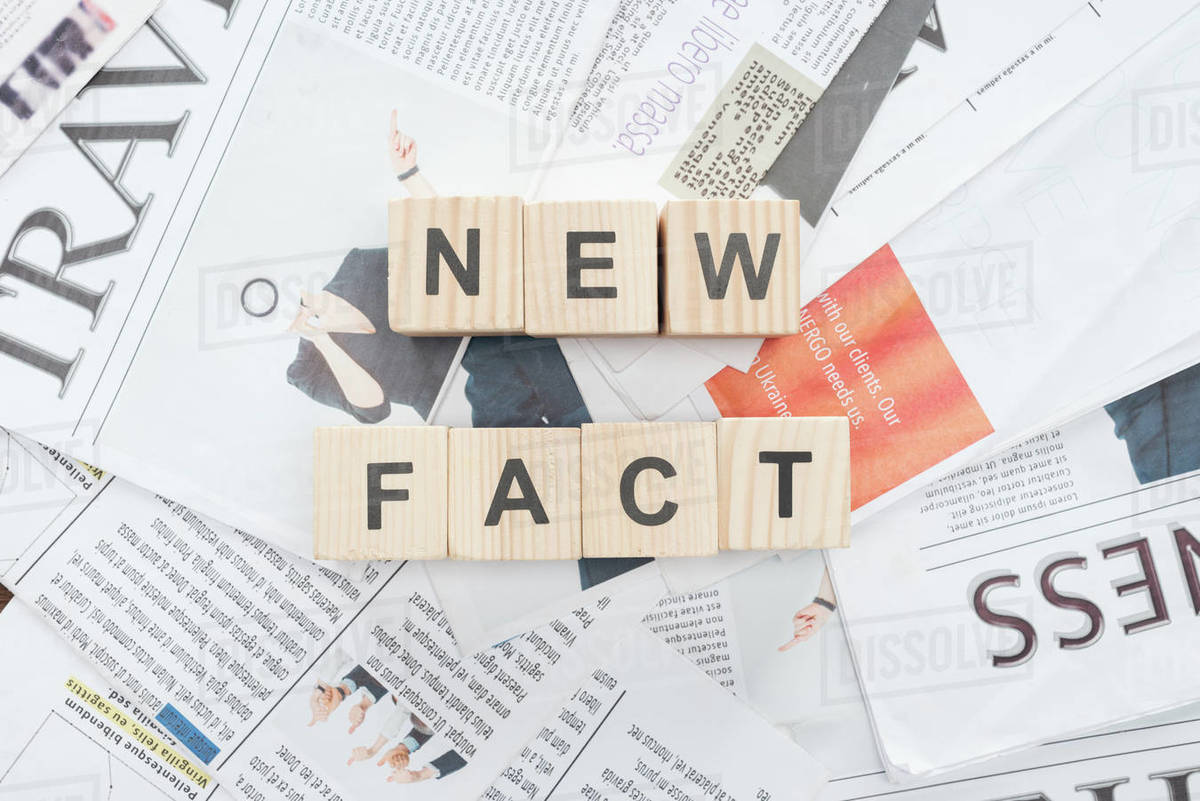 Top view of wooden cubes with words news fact on newspapers - Stock ...