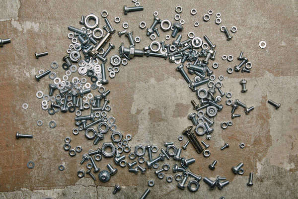 Top view of screws and bolts on the background of old surface - Stock ...