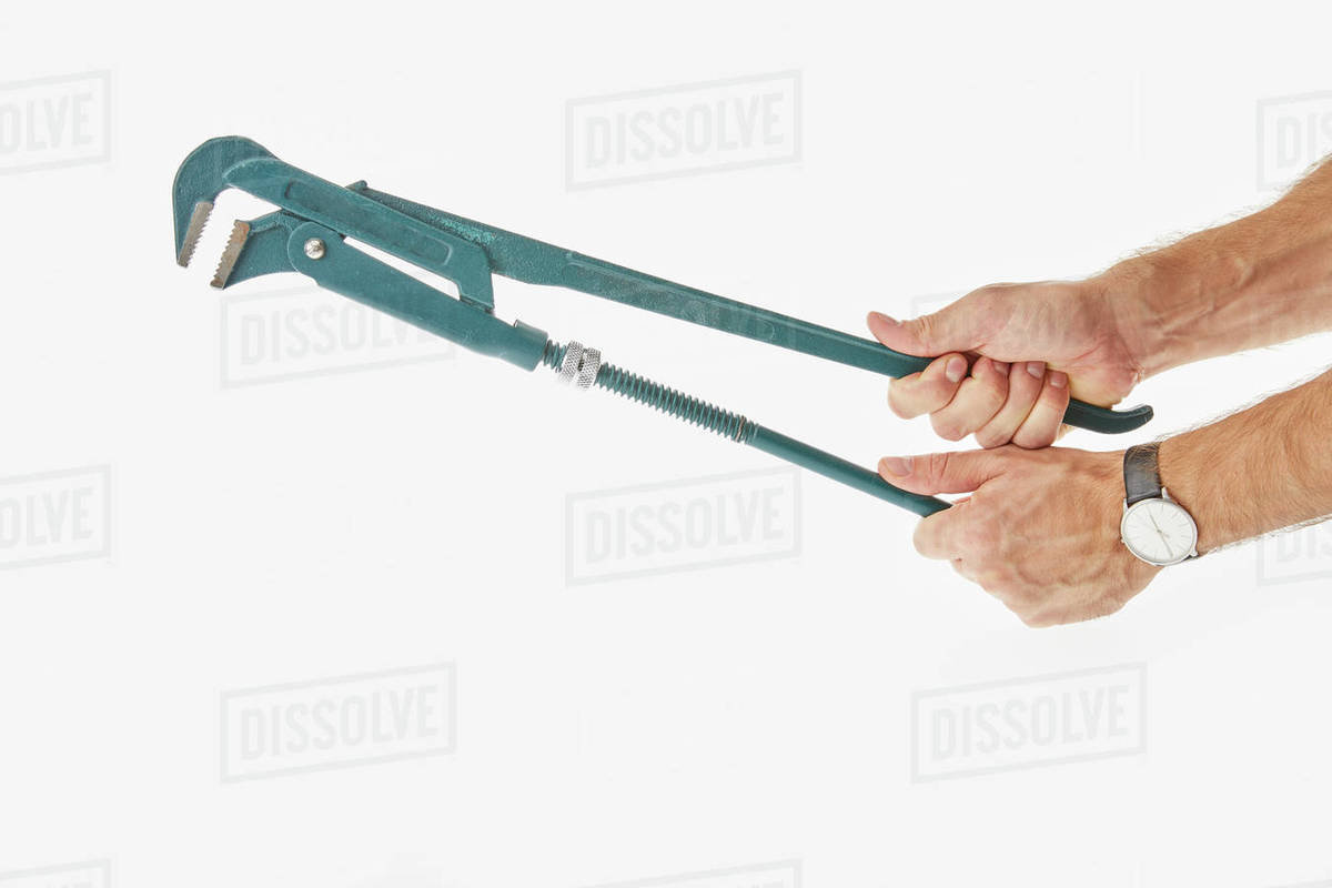 Partial view of man holding big blue pipe wrench isolated on white ...