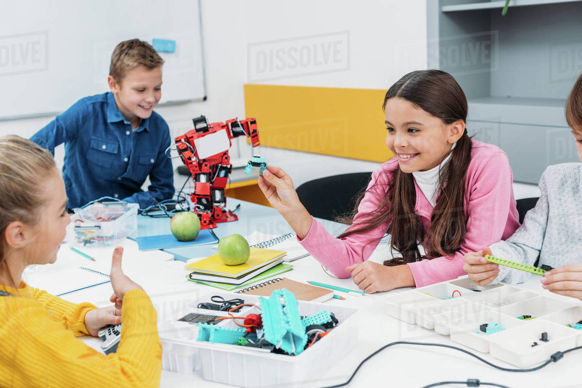 Happy schoolchildren working on robot at stem robotics lesson - Stock ...