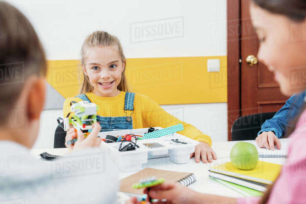 Selective focus of schoolgirl working with classmates together on stem ...