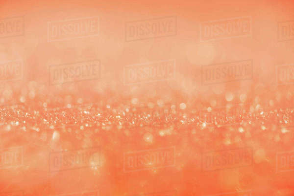 Abstract orange background with shiny glitter - Stock Photo - Dissolve