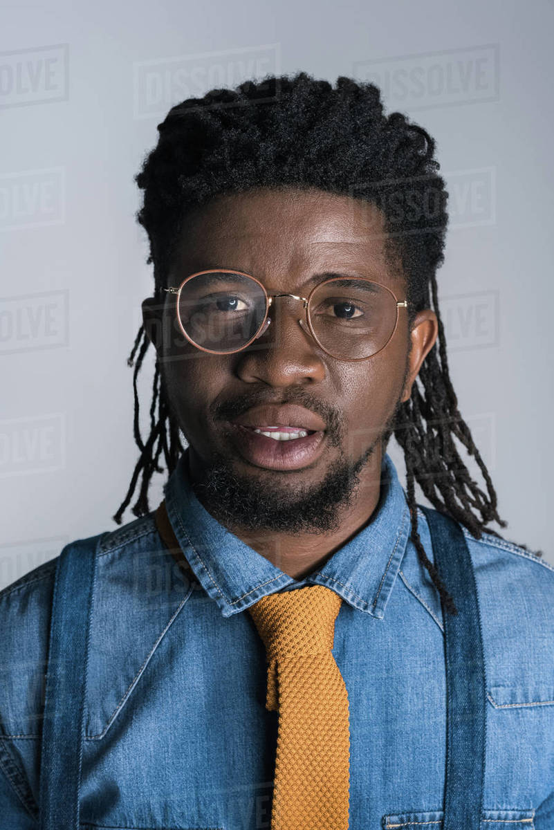 Portrait Of Handsome African American Man In Glasses Isolated On Gray