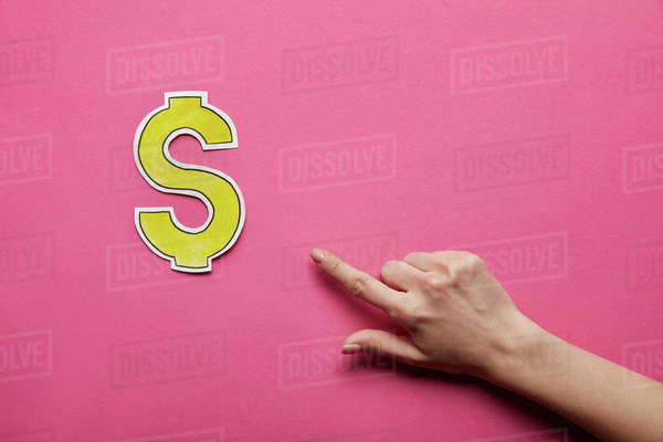 Top view of finger pointing at dollar sign on pink background - Stock ...