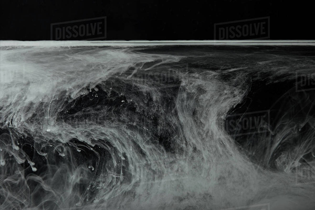 Abstract flowing swirls of grey paint in water - Stock Photo - Dissolve