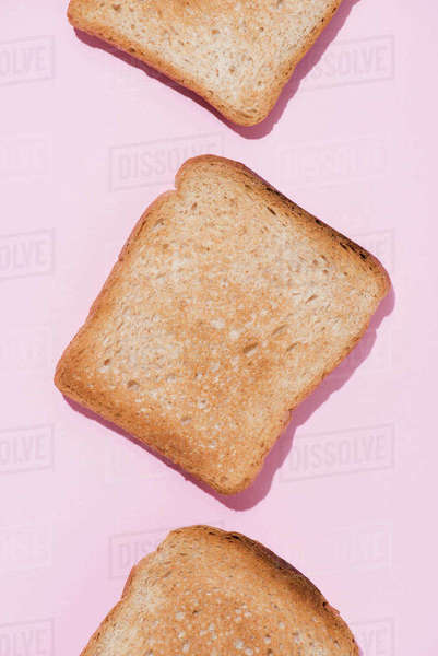 Top view of row of delicious toasts on pink tabletop - Royalty-free ...