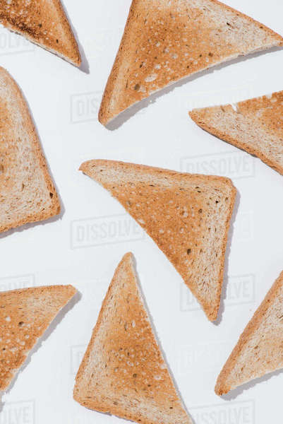 Top view of toasts cut in triangles on white surface - Royalty-free ...