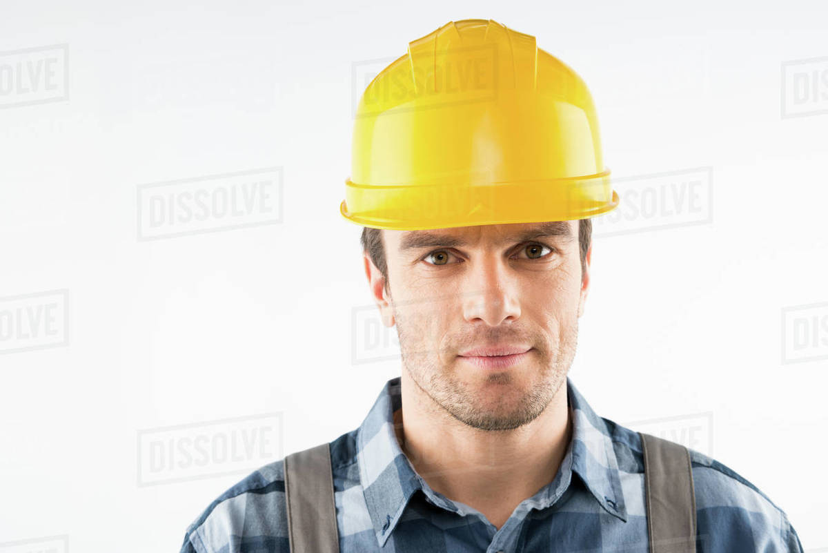 Close-up portrait of handsome male construction worker in helmet ...