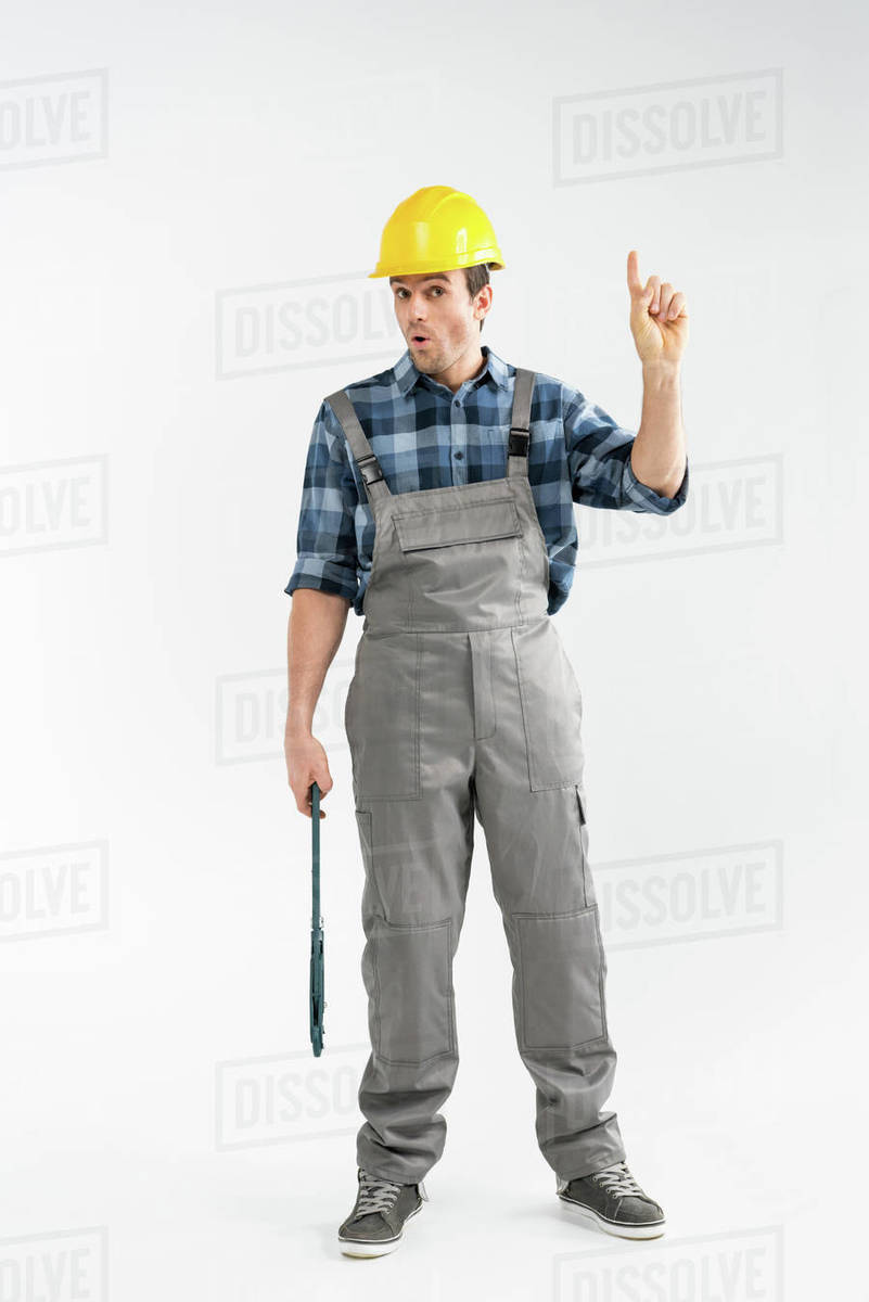 Professional male construction worker pointing up with finger isolated ...