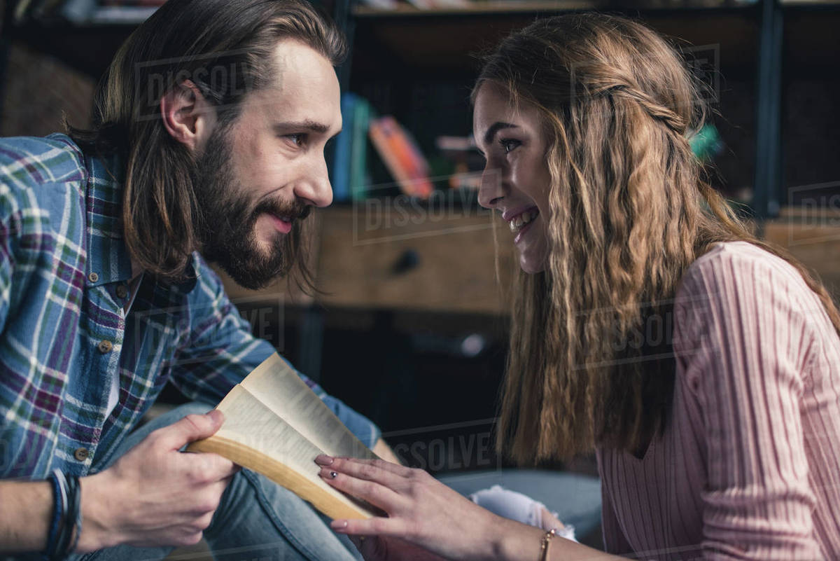 Happy young couple reading book together - Royalty-free Stock Photo ...
