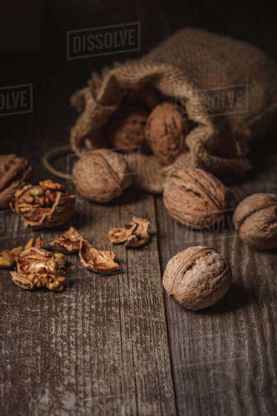 close up view of walnuts in sack on wooden background - Stock Photo ...