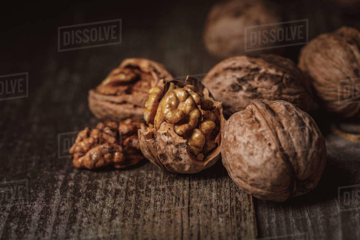 close up view of shelled and whole walnuts on wooden tabletop - Royalty ...