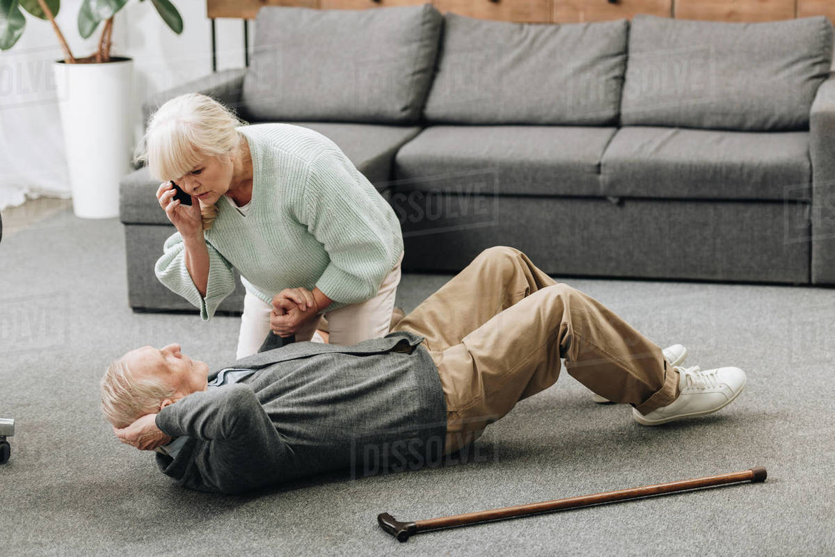 Senior woman holding hand of dying old man with walking stick - Royalty ...