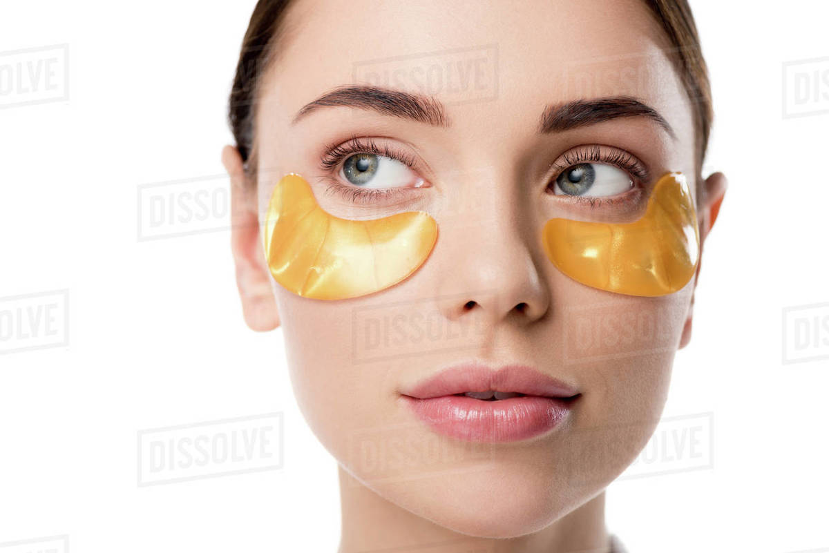 Close up of beautiful woman with golden eye patches isolated on white ...