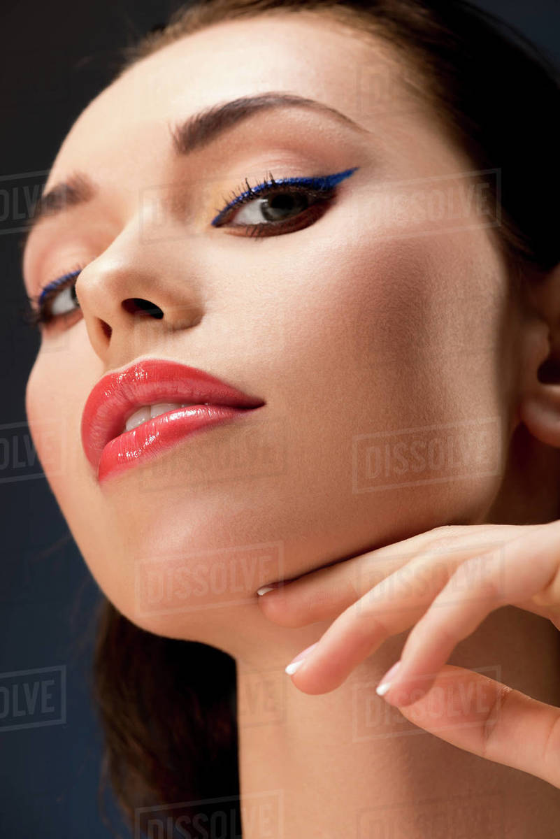 Portrait of beautiful woman with glamorous makeup looking at camera ...