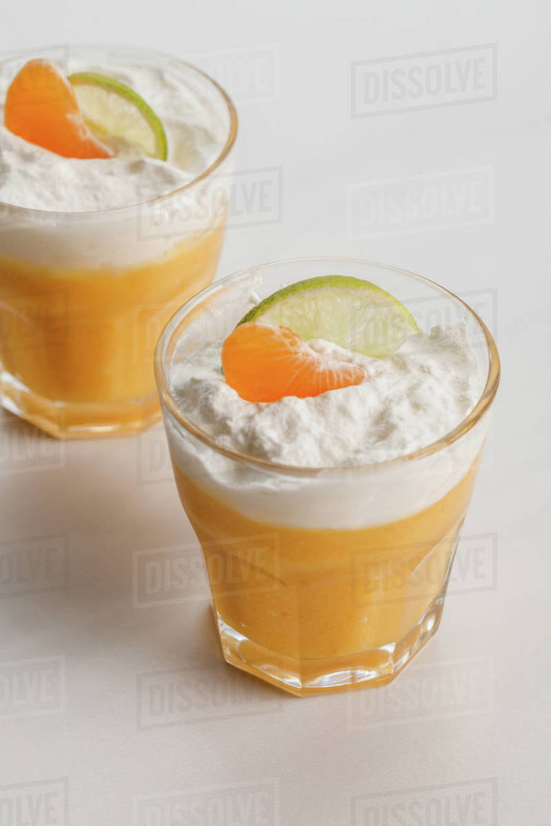 Orange mousse with tangerine and lime slices in glasses - Royalty-free ...