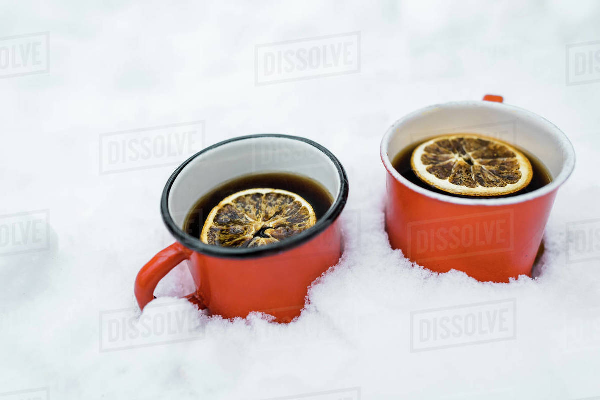 Red cups of tea with lemon staying on snow - Royalty-free Stock Photo ...