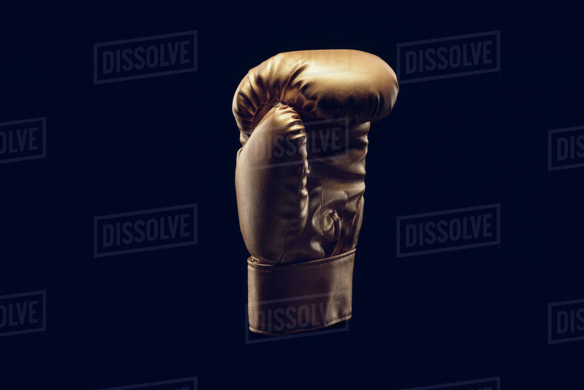 Close up view of golden boxing glove isolated on black - Royalty-free ...
