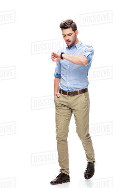 Handsome man walking and looking at watch isolated on white - Stock ...