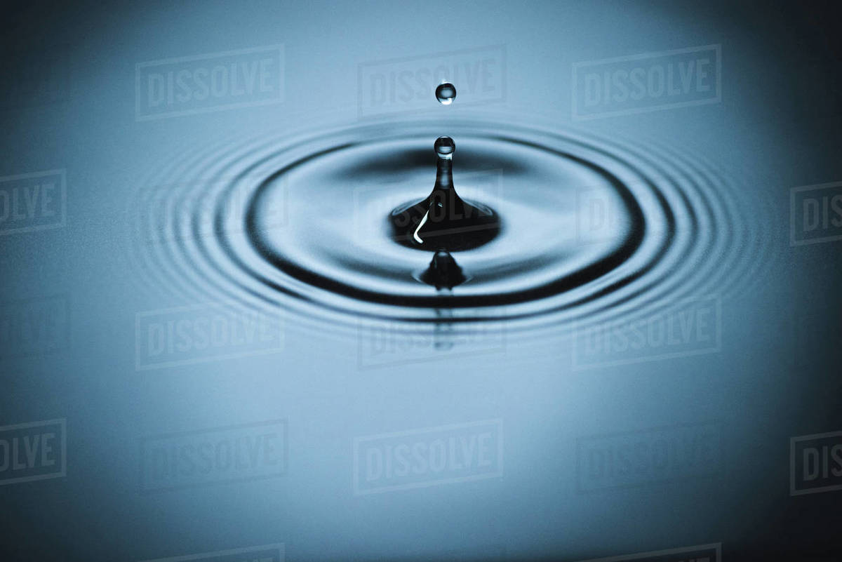 Splash of water drop on water surface - Stock Photo - Dissolve