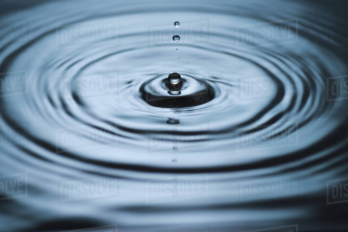 Splash of water drop on water surface - Royalty-free Stock Photo | Dissolve