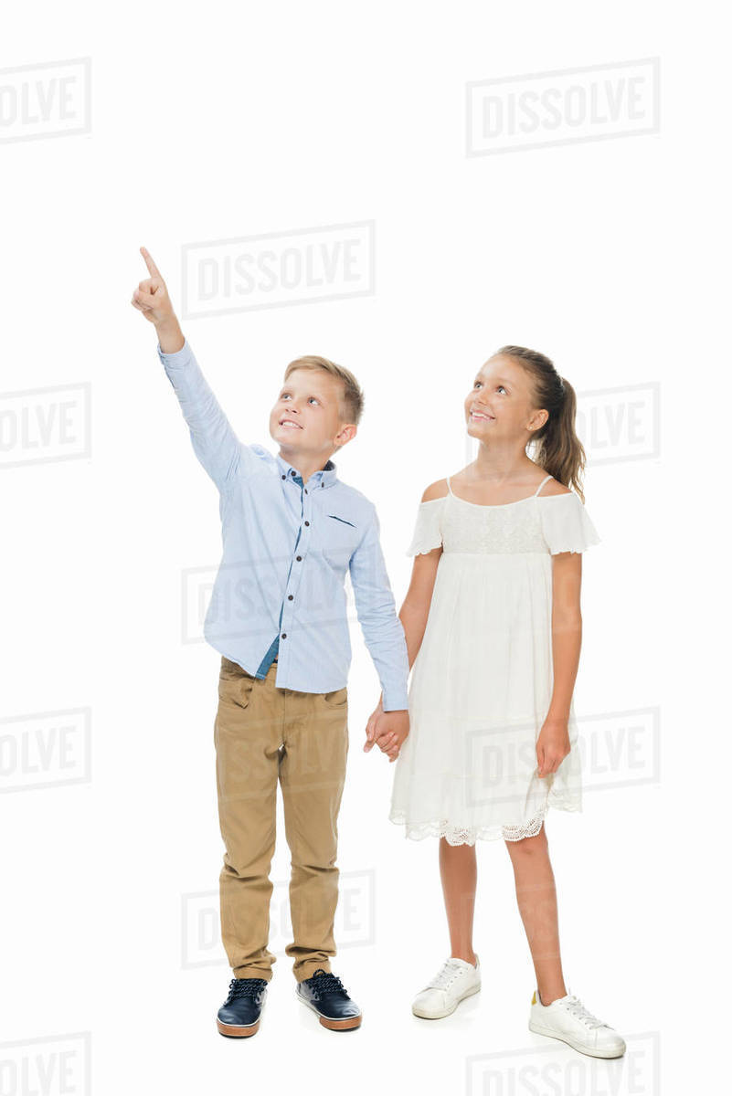 brother and sister holding hands and pointing somewhere, isolated on ...