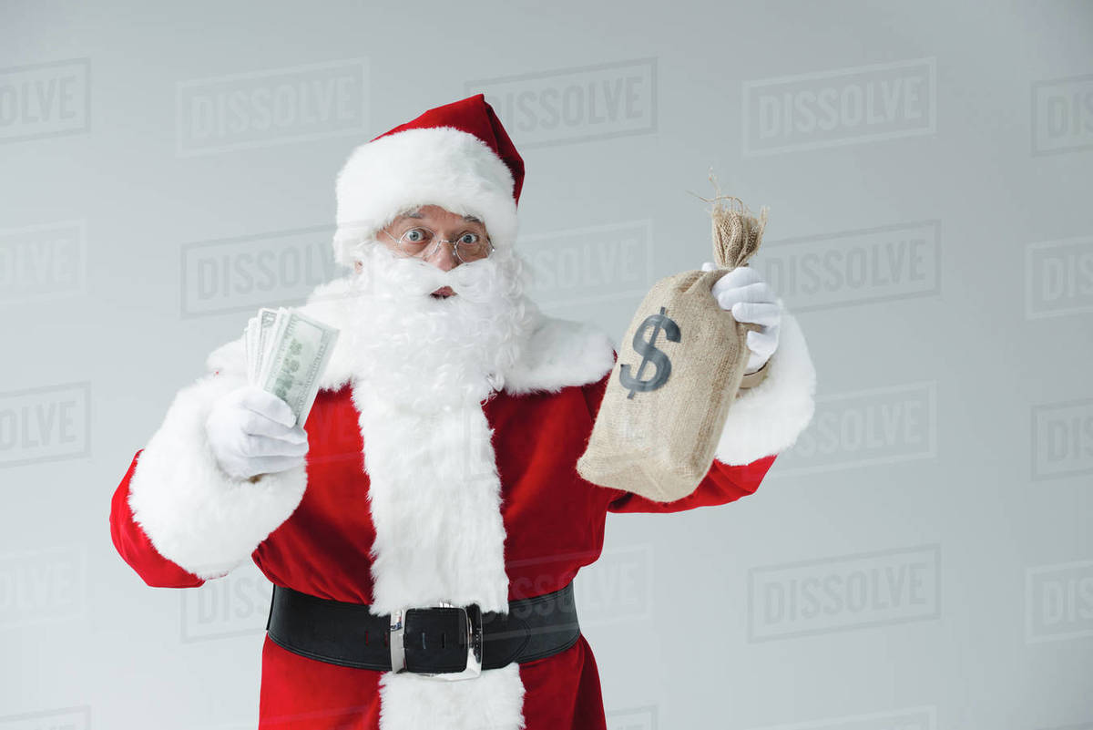 surprised santa claus holding dollar banknotes and money bag isolated ...