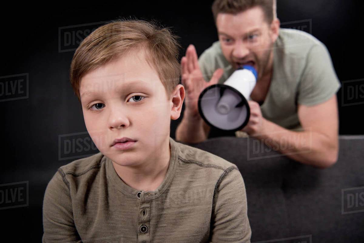 Father with megaphone screaming at scared little son, family problems ...