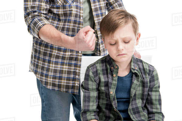 Cropped shot of father threatening and gesturing to scared little boy ...