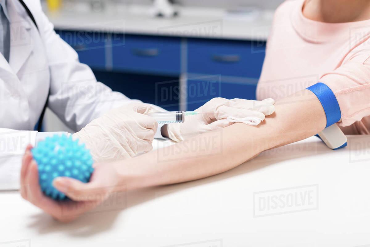 Cropped shot of doctor taking blood sample from patient at laboratory ...