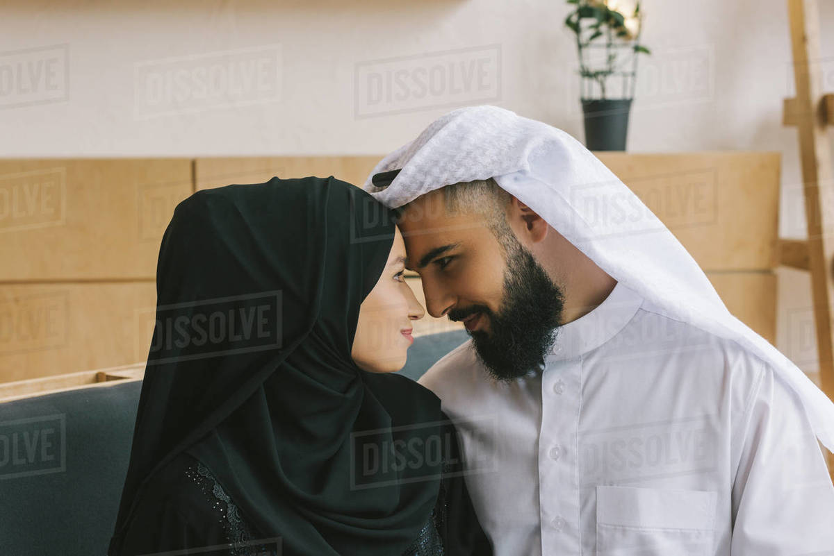 muslim couple in traditional clothing in love looking at each other ...